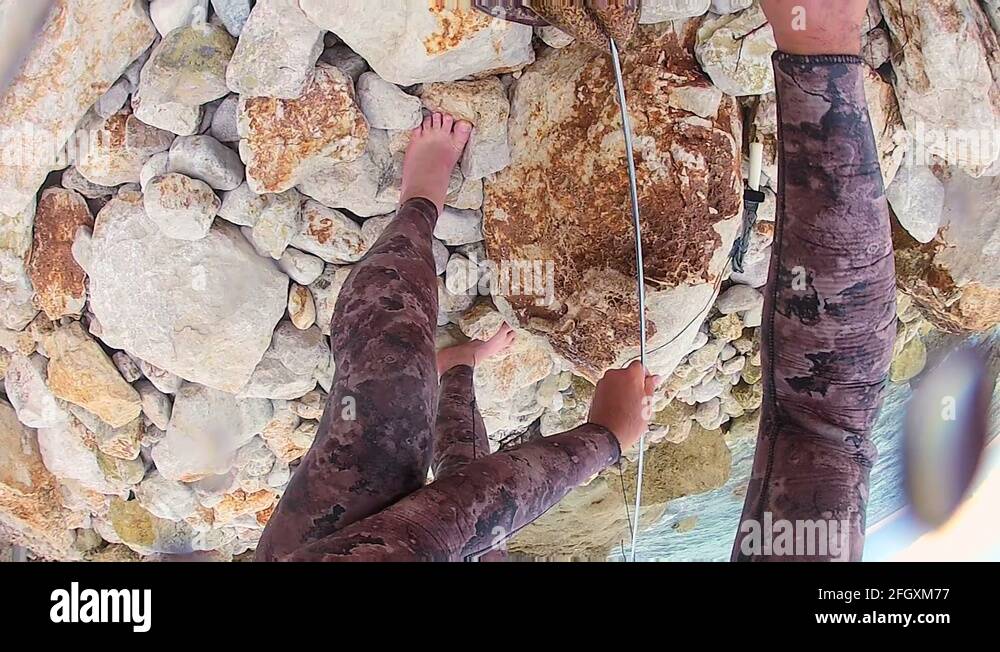 Man kills moray eel fish with a stone caught with a speargun on the ...