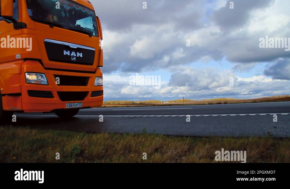 Driver starts motion of the cargo TIR transportation truck from parking ...