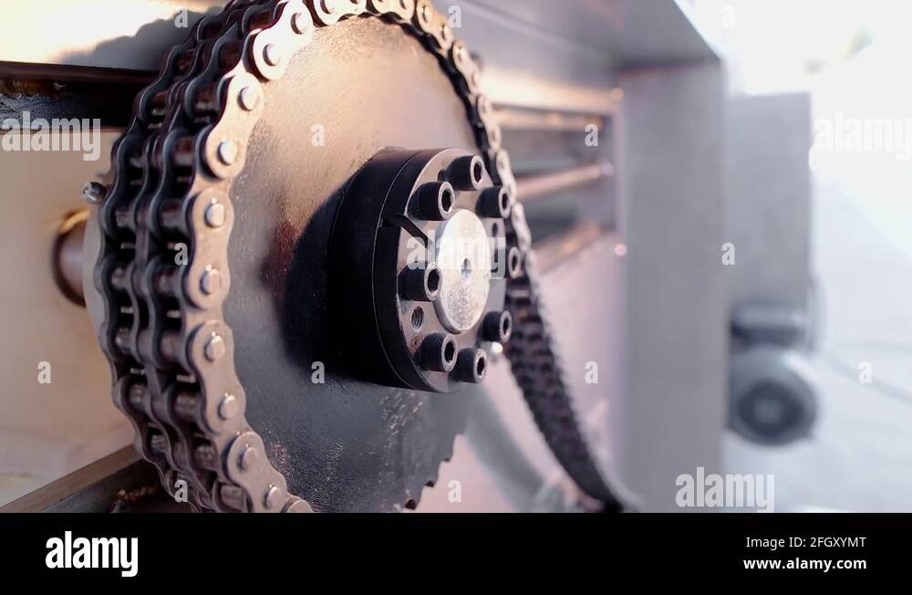 Metal pulley belt and gears with chain turning. Close up. Slow motion ...
