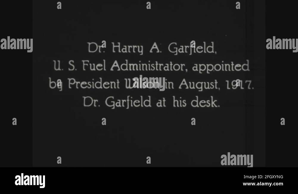 Harry Garfield attends to a call, signs a document at his desk - 1917 ...