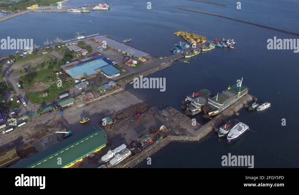 Fishing port and dock yard where boats are anchored side by side. Drone ...