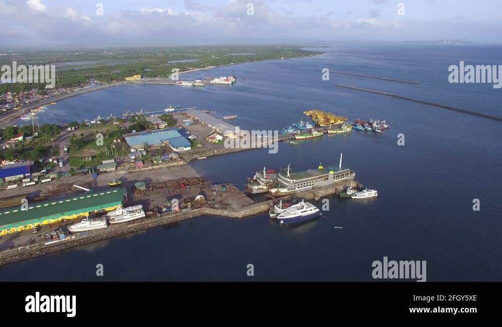 Fishing port and dock yard where boats are anchored side by side. Drone ...