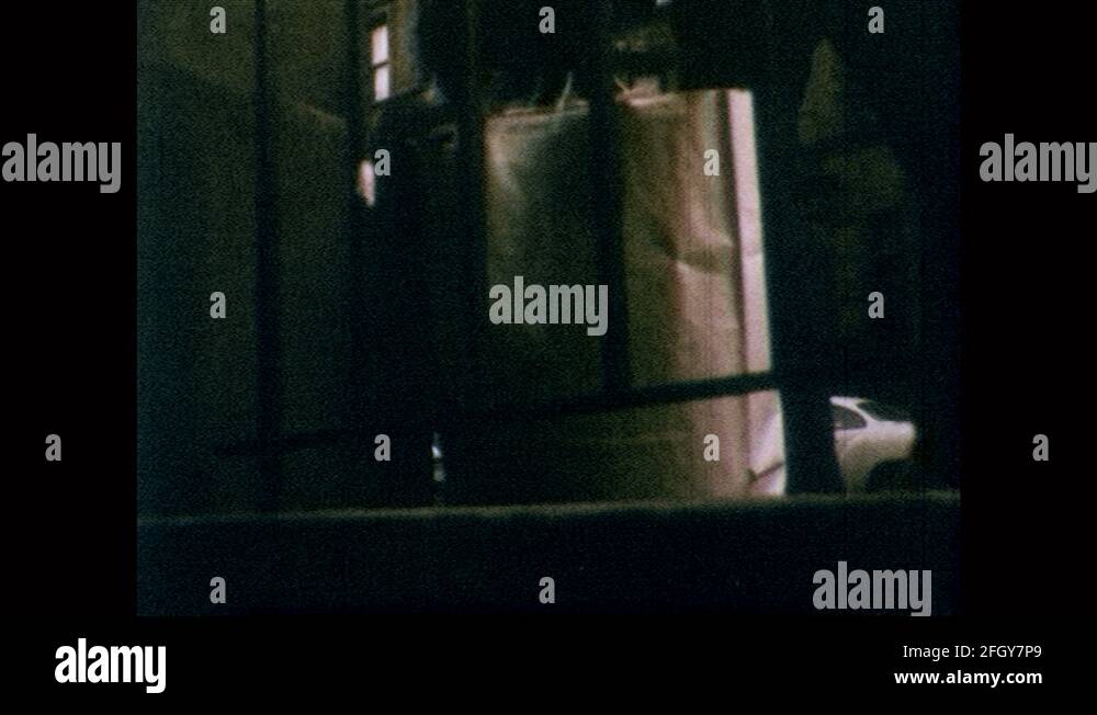 1970s: Man sets bag of trash next to railing. Another person adds a bag ...