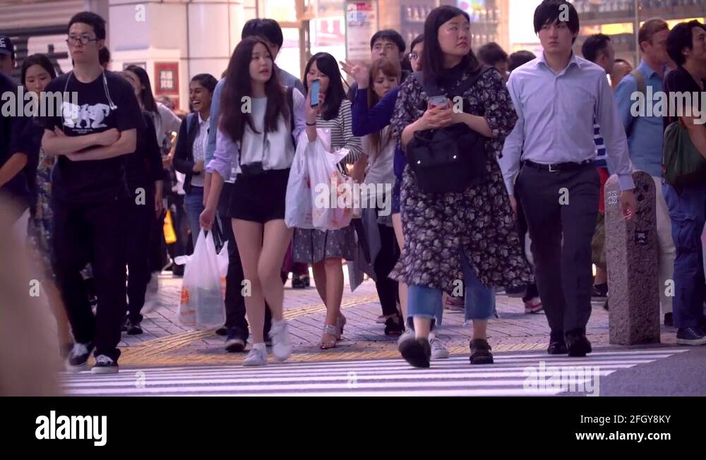People cross the famous intersection in Shibuya, Tokyo, Japan Stock ...