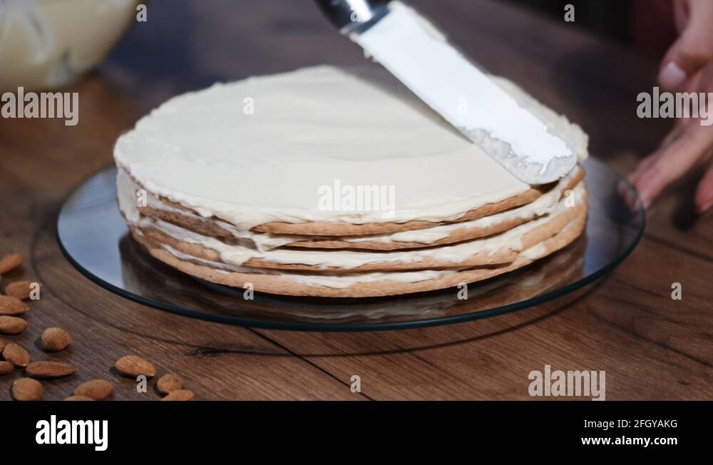 Stacking cake layers. Making torte with buttercream filling Stock Video ...