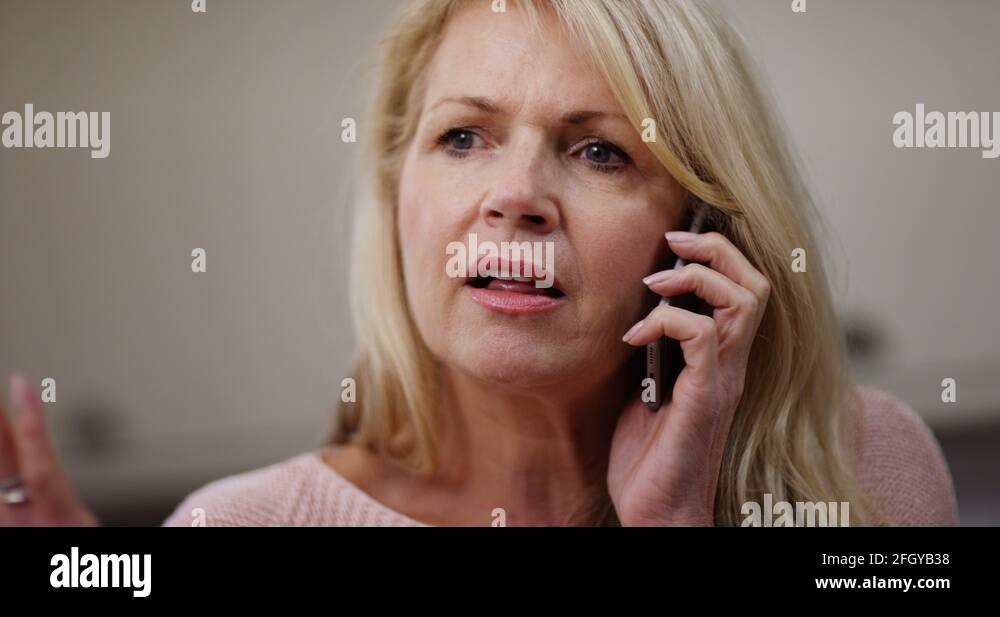 4K Confident angry mature woman arguing over the phone & hanging up ...