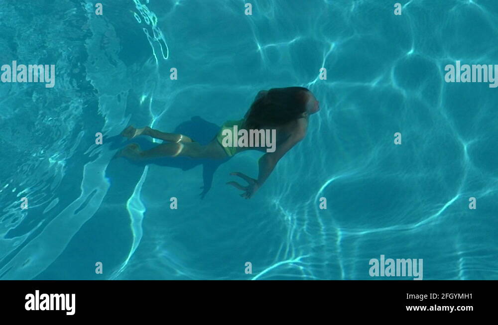Girl jumping into the water in the pool Stock Video Footage - Alamy