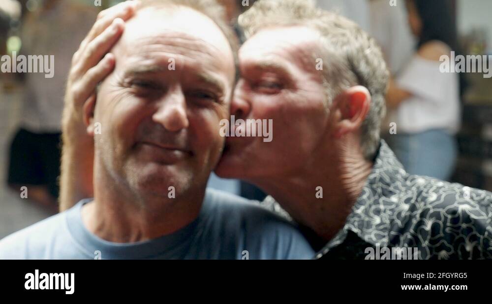 Profile of two affectionate men joking with each other in a bar Stock ...