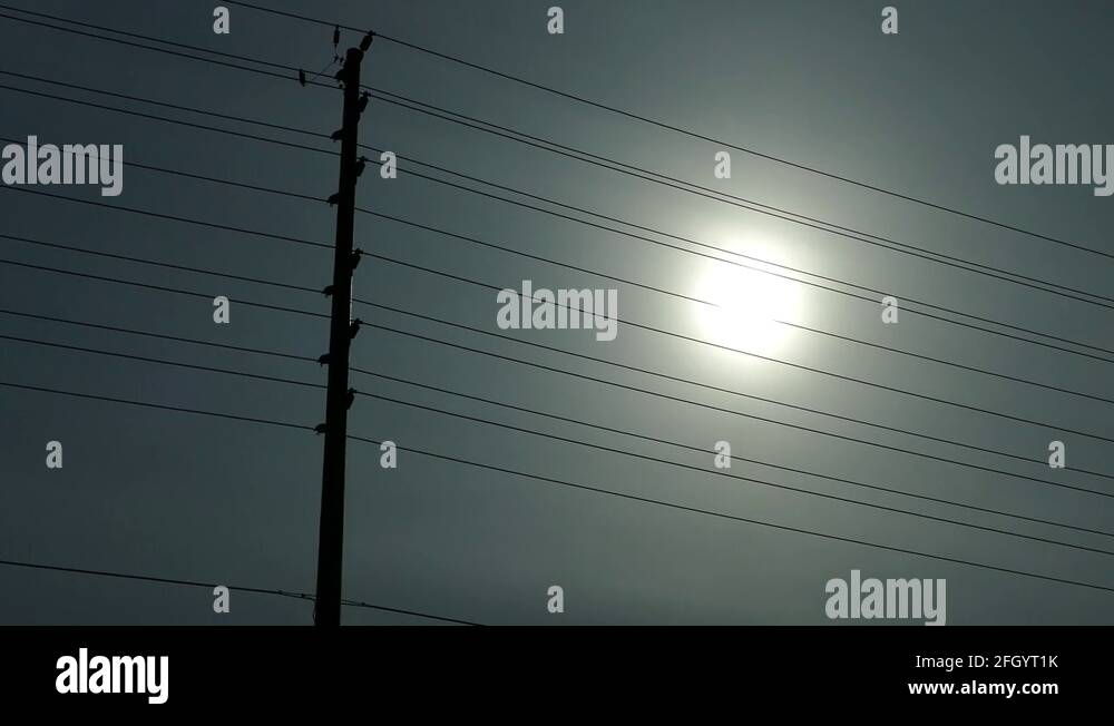 Sun over electrical power transmission lines Stock Video Footage - Alamy