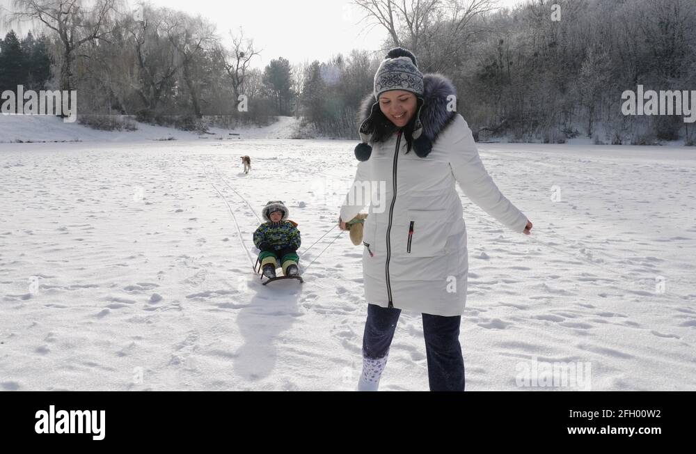 Young mother rolls her son on sledding Stock Video Footage - Alamy Young mother rolls her son on sledding Stock Video Footage - Alamy