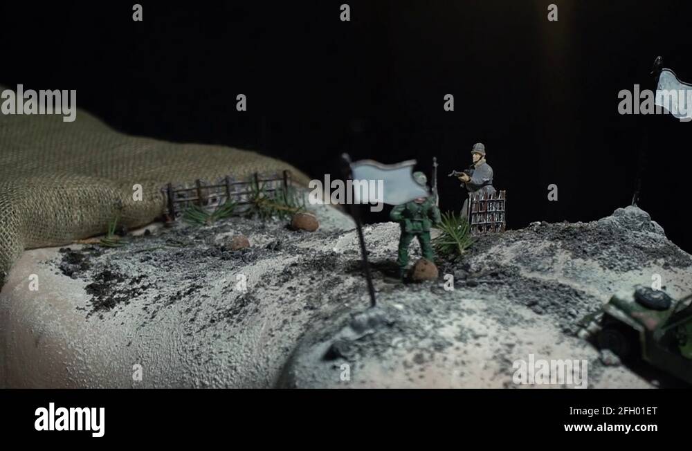 Miniature toy soldiers fight between two hills during an earthquake ...