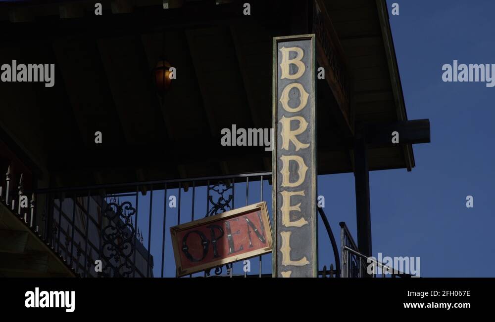 Old west town bordello sign on building for prostitution and whiskey ...