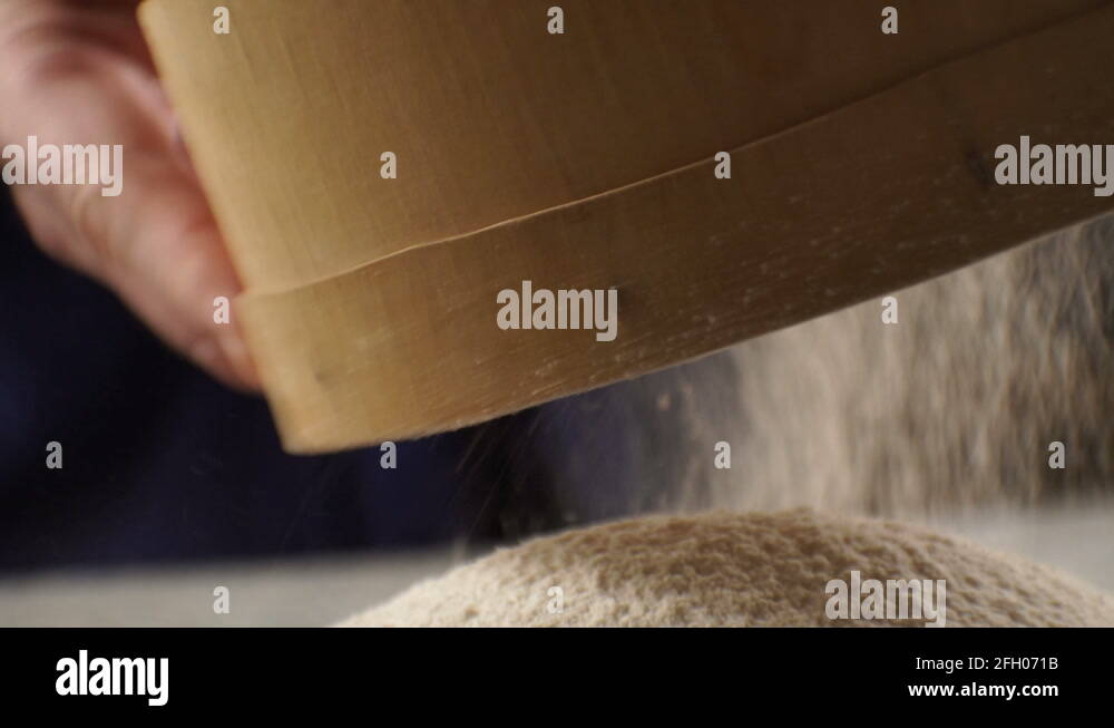 Sifting whole-grain flour through a sieve side view. Video Stock Video ...