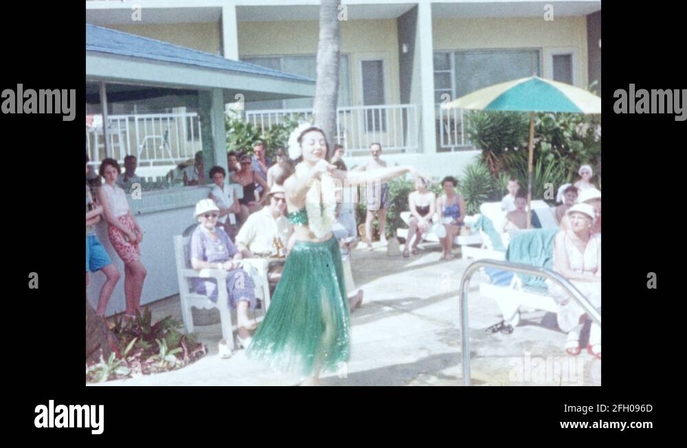 1940s: Woman performs hula dance by pool for audience. Women model ...