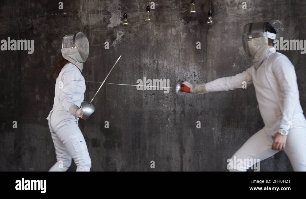 Two athletes train fencing racks in the fitness club, show the attack ...