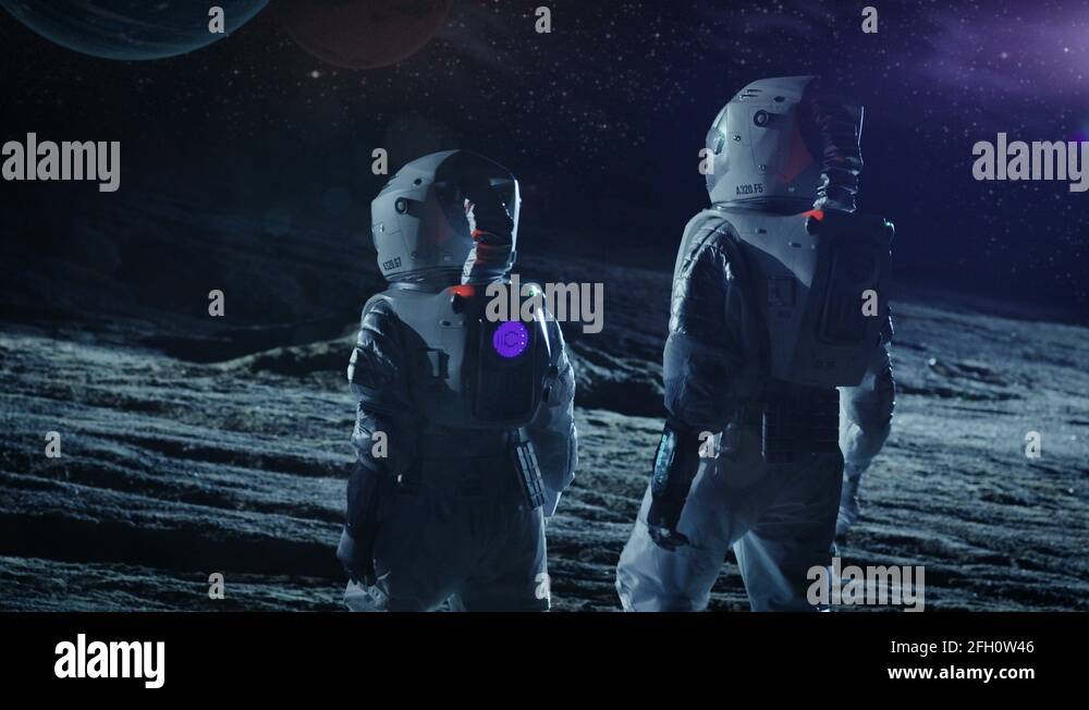 Two Astronauts in Space Suits Standing on the Alien Planet Look at Two Planets Stock Video ...