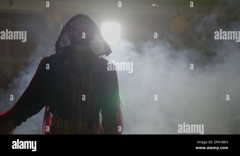 Scary actor dressed in a frightening halloween costume doing spooky ...