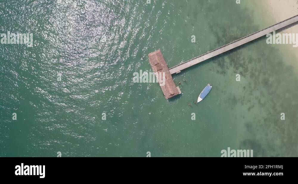 Gliding birds eye view of docks and beaches in the Malaysian tropics in ...