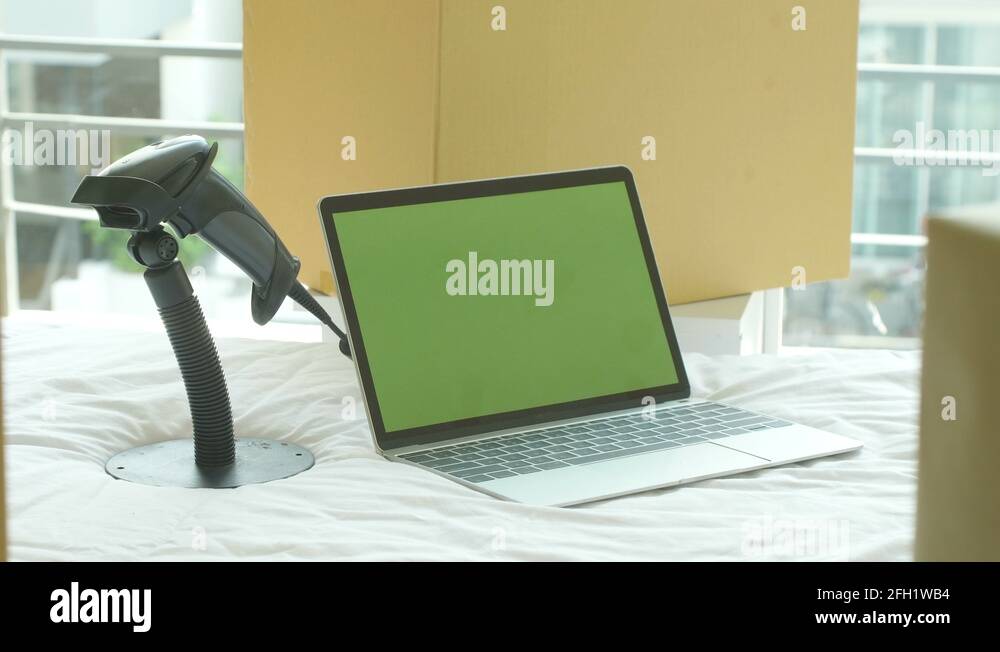 laptop computer with green screen chroma key with cardboard boxes ...