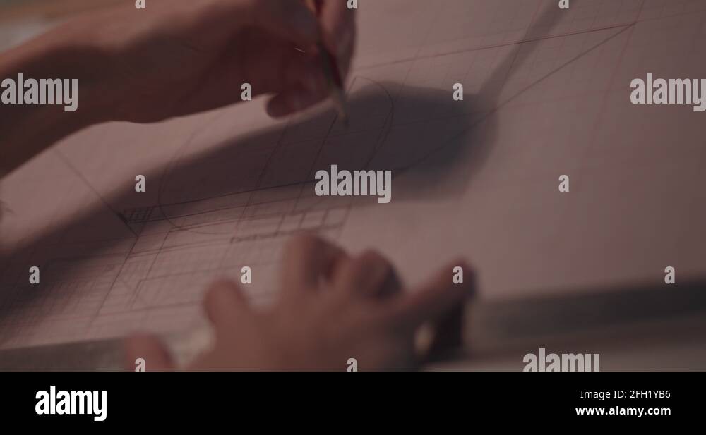 Close-up of woman architect's hands drawing architecture blueprint at ...