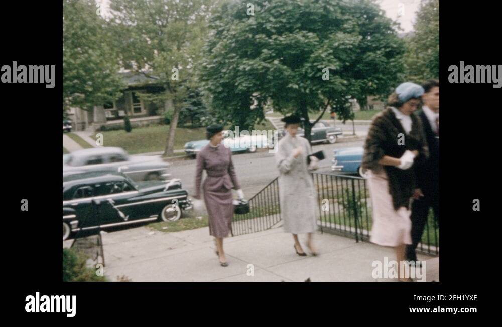 1940s: Guests walk up church steps. Women in suits and hats and little ...