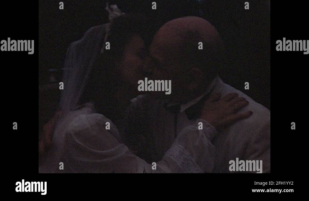 1940s: Bride and older man kiss. Bride, groom, and father of the bride ...