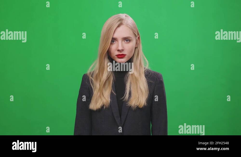 Beautiful girl shows emotions, actor play, sad, green background Stock ...