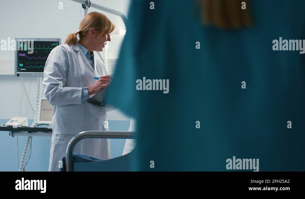 In the Hospital Professional Female Doctor Asks Questions to the ...