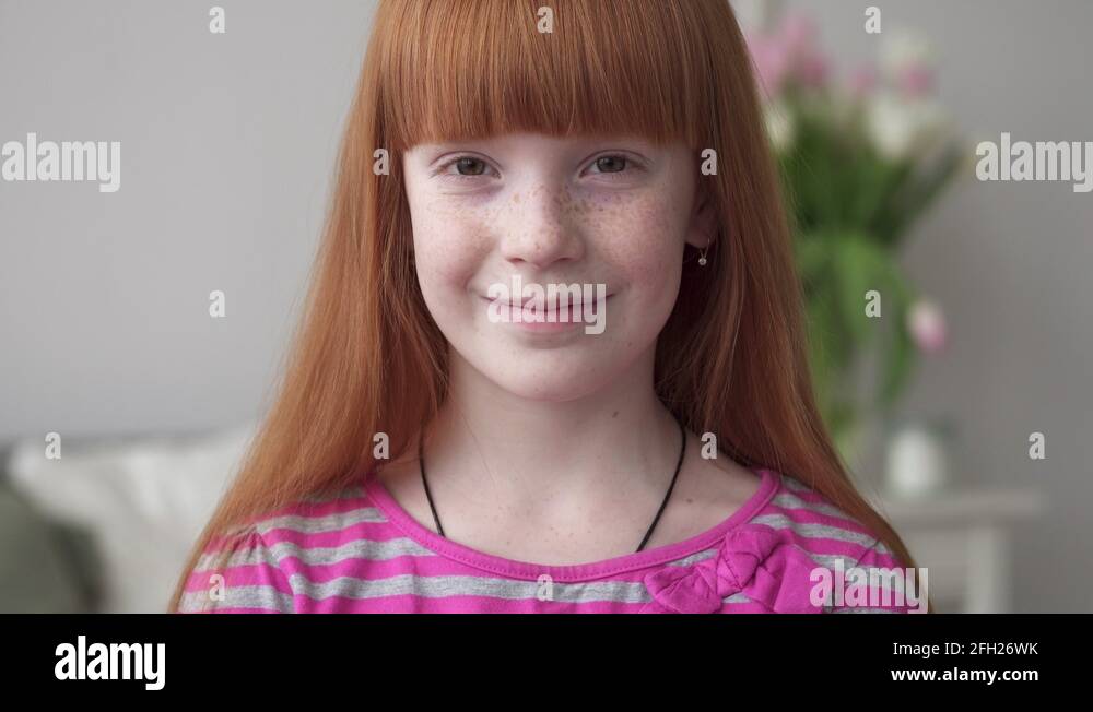 Little happy ginger girl with freckles smiling in a white room Stock ...