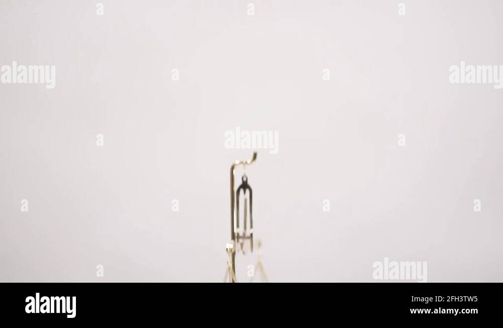 Tilt down to spinning scale on isolated white background Stock Video ...