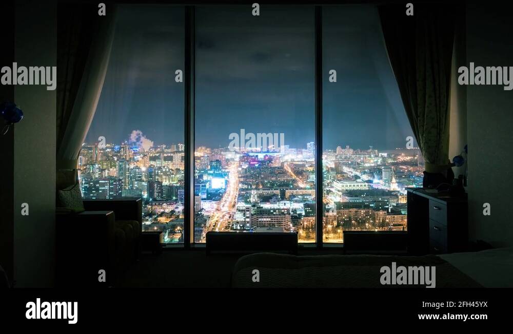 Night city skyline view from empty dark room panoramic window ...