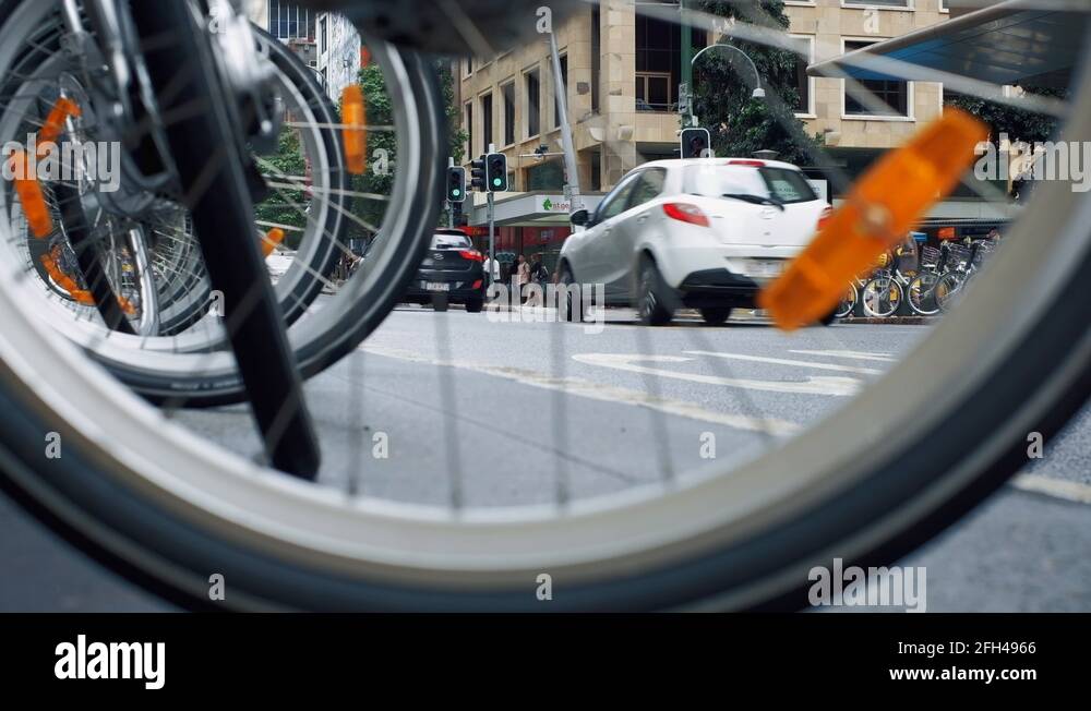 Brisbane - Street view with traffic viewed through bike wheel. 4K Stock ...