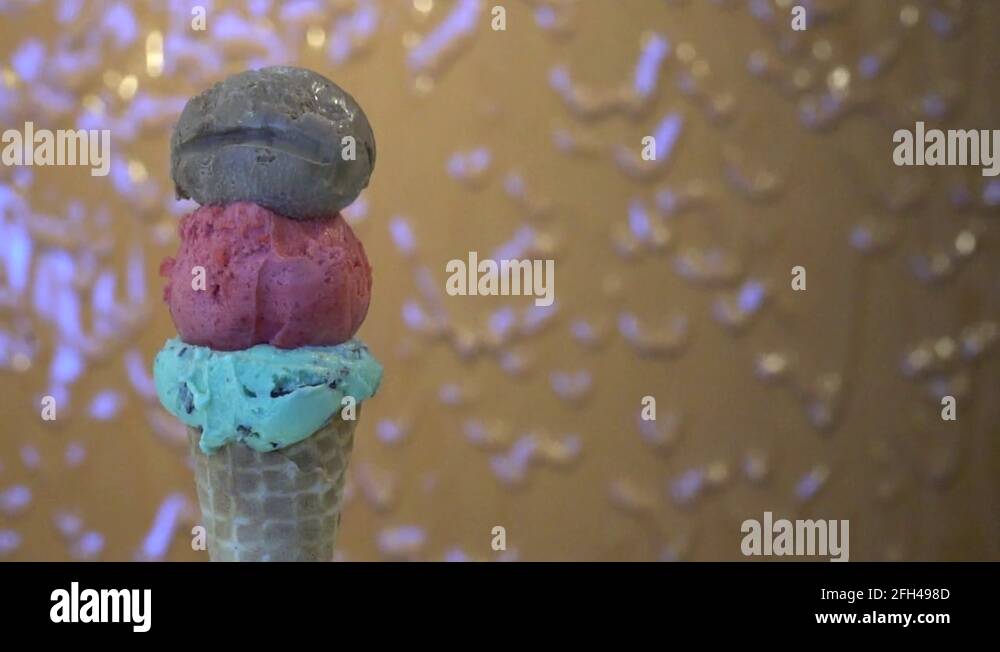 chocolate ice cream corn and liquid chocolate falling on it on bright ...