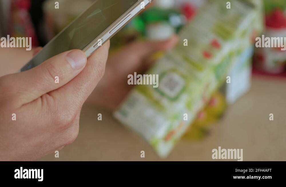 A man scans the QR code on a check on a juice box from a supermarket ...