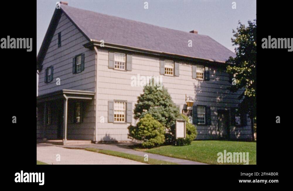 1950's: Shingled meeting house; building with ionic columns; sign reads ...