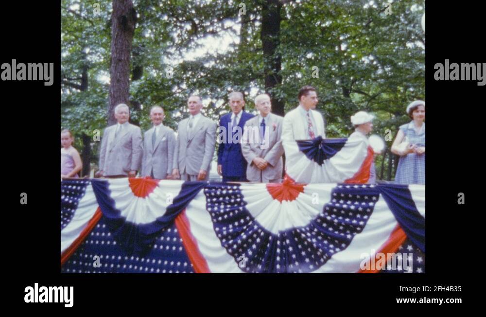 1950's: Men in suits applaud from reviewing stand; soldiers in uniform ...