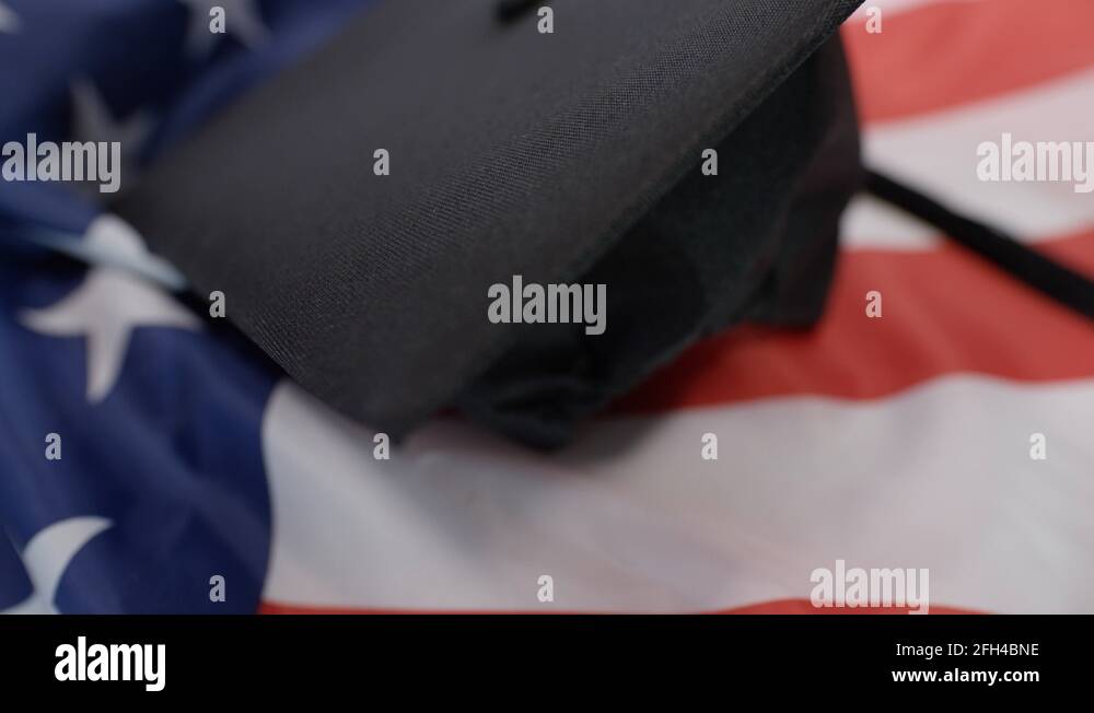 Tilt up graduation cap and american flag Stock Video Footage - Alamy