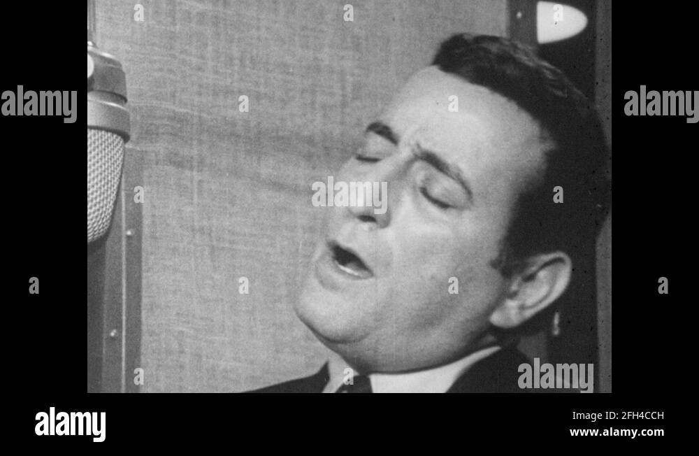 1960s: Vocalist sings into microphone and reads music. Tony Bennett ...
