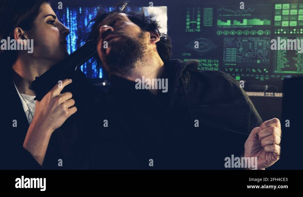 Police woman interrogating criminal hacker handcuffed in front of ...
