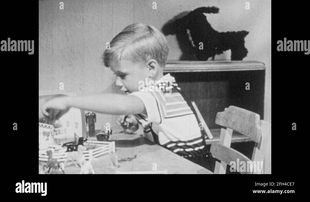 1950s Boy Does Imaginative Play With Farm And House Figures On His Play Table Stock Video 1950s-boy-does-imaginative-play-with-farm-and-house-figures-on-his-play-table-stock-video
