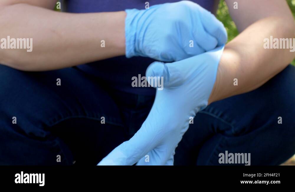 Female Police Detective Putting On Latex Gloves Close Up Front View
