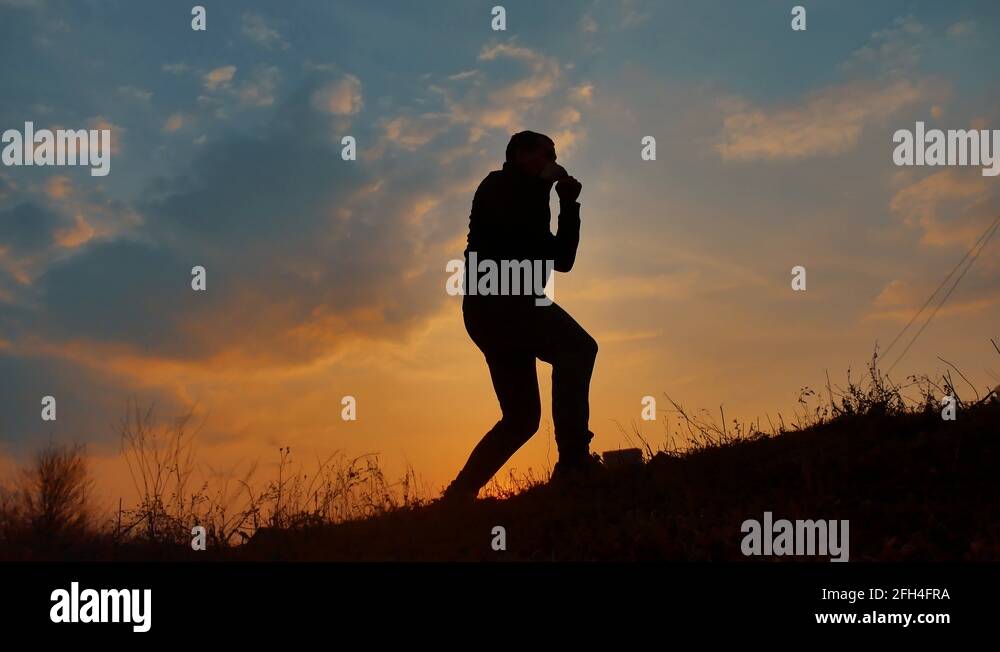 man boxer boxing on nature silhouette sunset sunlight. kickboxer the ...