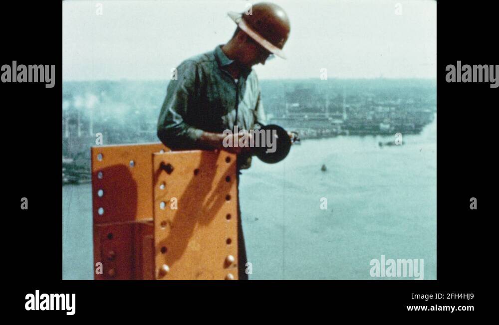 1950s: Man holds plumb bob weight. Man holds weight and looks up. Man ...