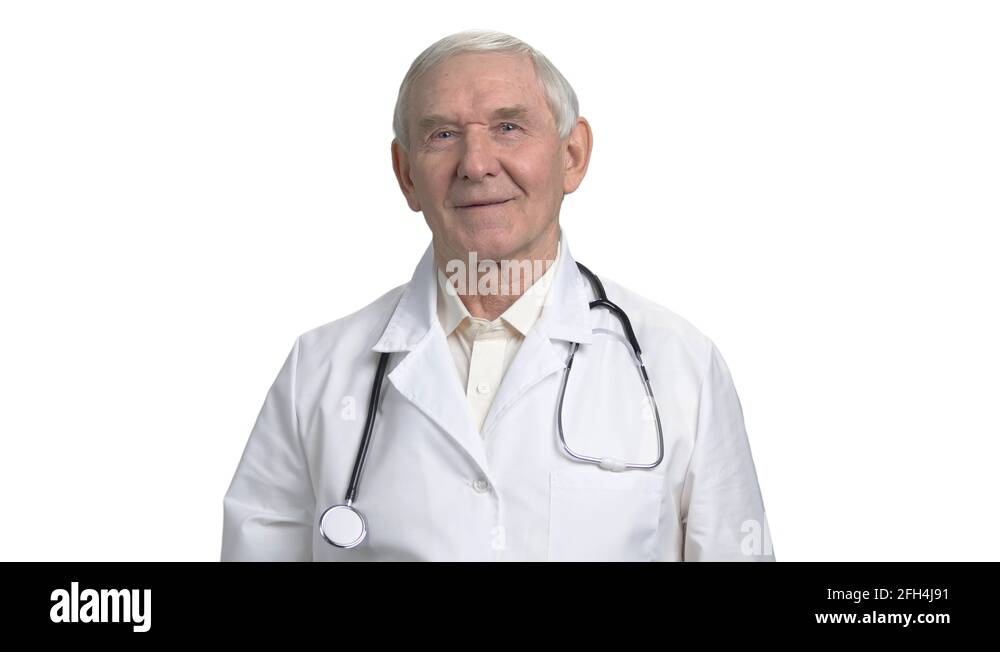 Senior old grey hair doctor in uniform pointing a medicine in strip ...