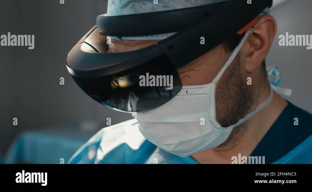 Portrait of surgeon using augmented reality hololens headset during ...