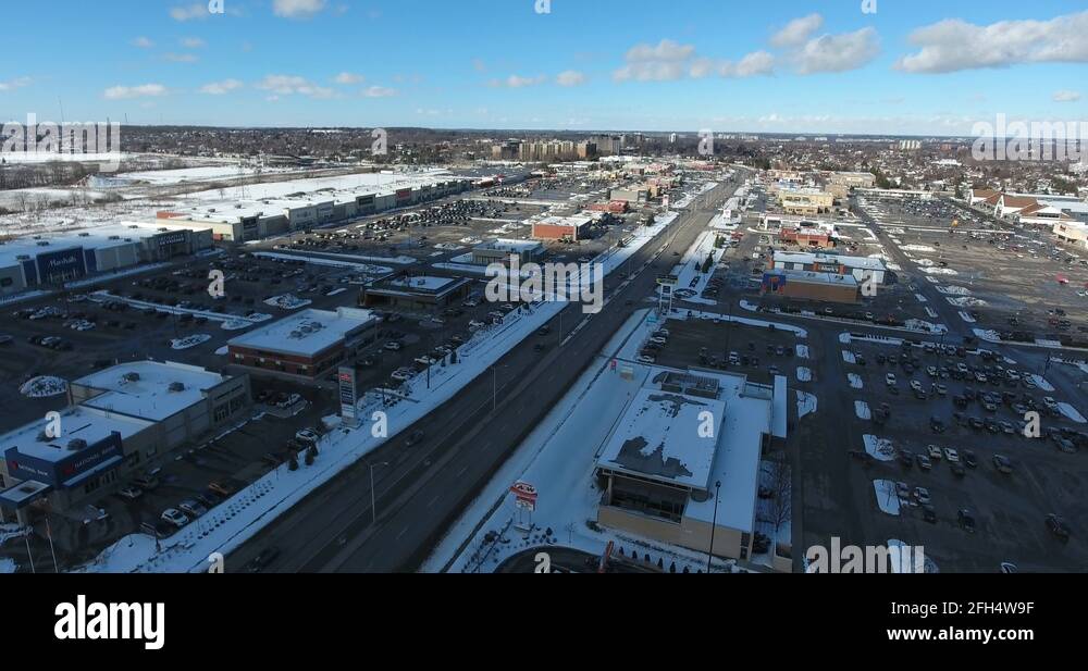 Descending Aerial View Of Strip Mall Shopping Complex In Winter Stock ...