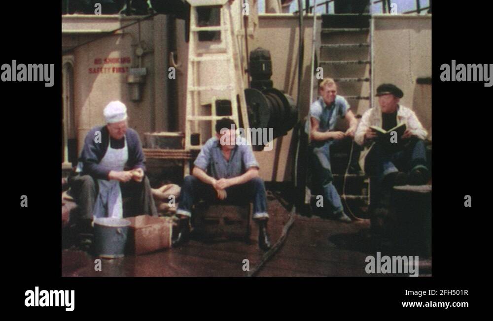 1950s: Men on ship deck, man talking. Dissolve, men carry bags into hut ...