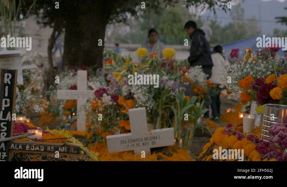 Cross and grave markers in a Mexican graveyard during day of the dead ...
