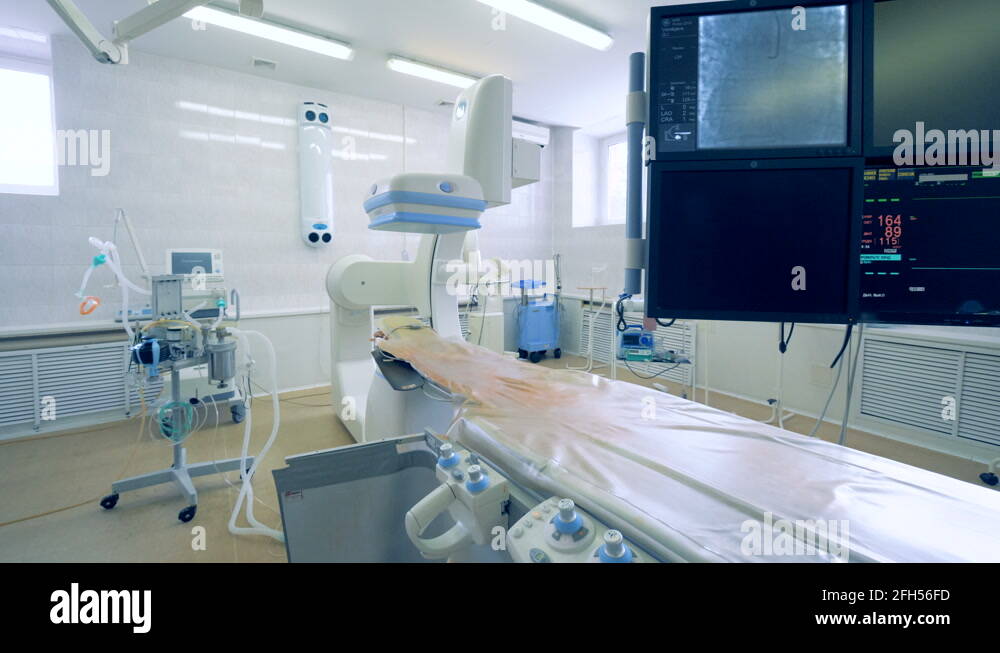 An operating room with a special table and heart monitors at a clinic ...