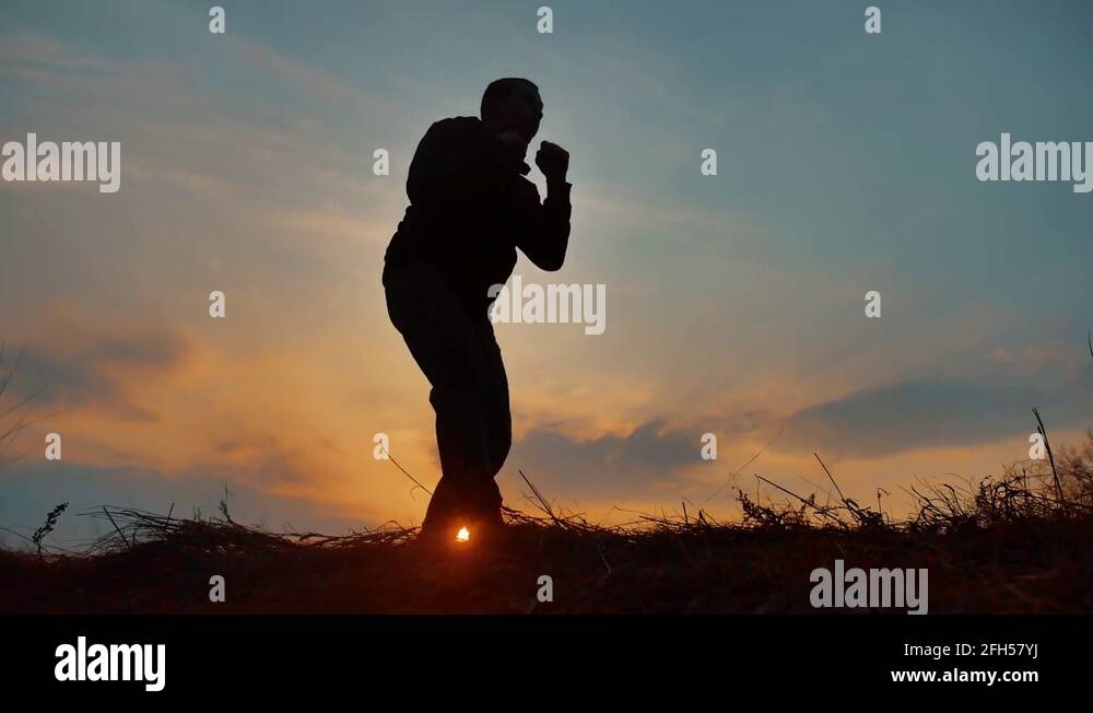 man boxer boxing on nature silhouette sunset sunlight. kickboxer the ...